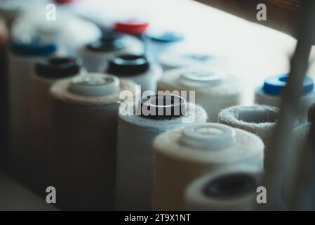 Sewing concept. Lot of thread coils next to the sewing machine Stock ...