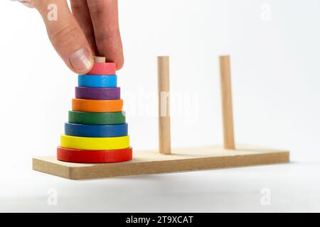 Closeup shot of a man solving the puzzle on the yellow background Stock ...