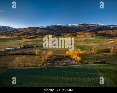 Aerial view of Llívia and its rural surroundings on an autumn sunset ...