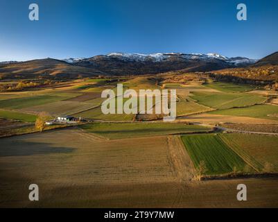 Aerial view of Llívia and its rural surroundings on an autumn sunset ...