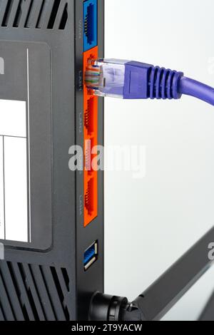 Modern router with cables plugged in close up Stock Photo - Alamy