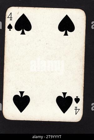 A vintage black four of spades playing card isolated on a white ...