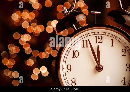 Black vintage alarm clock with christmas baubles and decor on dark ...