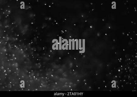 abstract dust particles on dark background with light spot Stock Photo ...