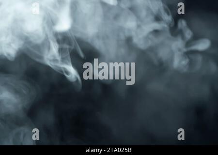 smoke slowly floating through space against black background Stock ...