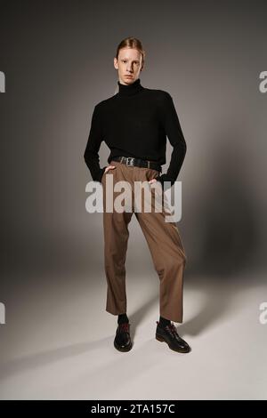 vertical shot of androgynous model in warm outfit with sunglasses ...