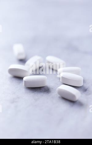 Beta - Alanine tablets. A dietary supplement on bright stone background ...