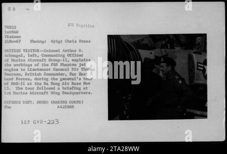 Colonel Arthur O. Schmagel of Marine Aircraft Group-11 congratulates a ...