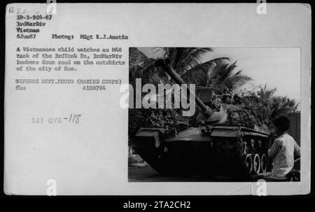 A tank of the 3rd Tank Battalion moves along a makeshift road in ...