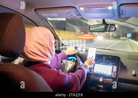 Pregnant Muslim woman using mobile phone at home Stock Photo - Alamy
