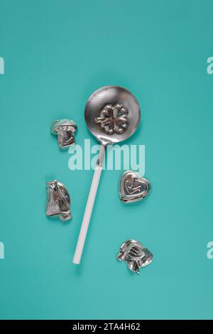 lead pouring set for New Years party.Tin spoon and tin figurines on a ...