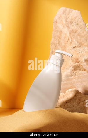 Bottle of sunscreen lotion against orange background Stock Photo - Alamy