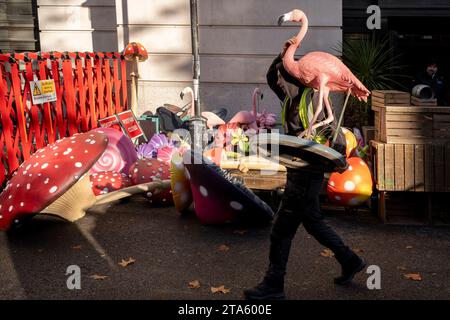 A work crew organises and carries fibreglass props including a headless ...