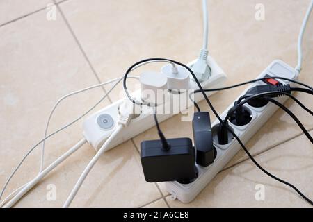 Overloaded power boards. Power strips with different electrical plugs ...