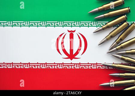 Many rifle bullets with flag of Islamic Republic of Iran. The concept ...