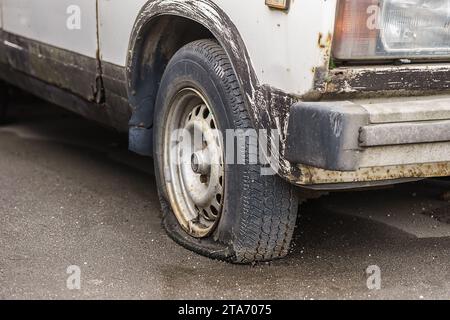 Sheet metal corrosion over wheel of old white car. Rusty messy surface ...