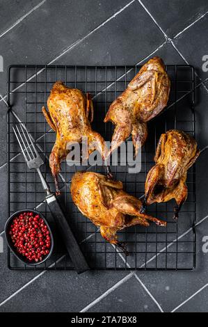 Grilled whole quails with herbs and spices. Isolated, white background ...