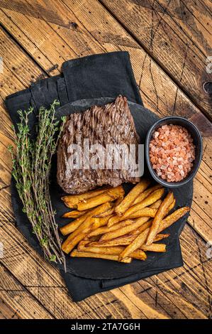 Venison dear steak with sea salt and french fry, game meat. Wooden ...