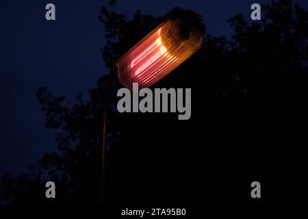 SOX Sodium, LPS or low pressure sodium lamp warming up. The pink/red ...