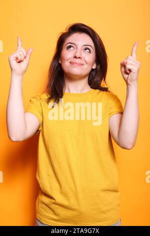 Photo of excited cheerful lady indicate finger arm hold dollars ...