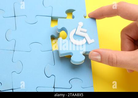 Inclusion concept. Woman putting light blue puzzle with international ...
