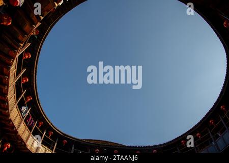 The sky above the round buildings of Hekeng Tulou Cluster in the early ...