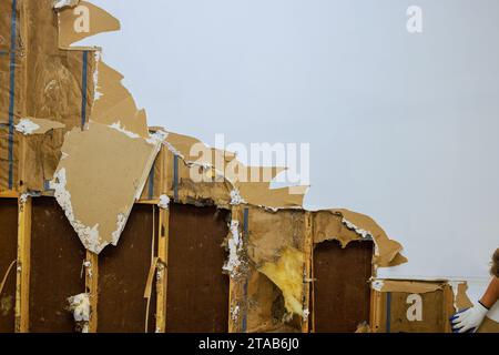 Dismantling old damaged plasterboard drywall during house ...