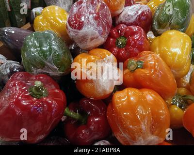 Plastic coated green, yellow, red bell peppers Stock Photo - Alamy