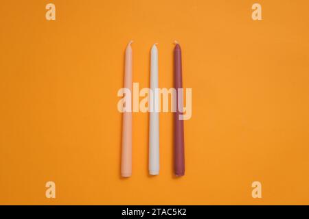 pastel colors background with pink burning candle on pink background ...