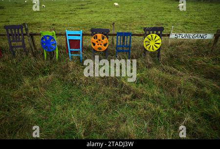 Art installation of a gallery, stool, humour, various folding chairs ...
