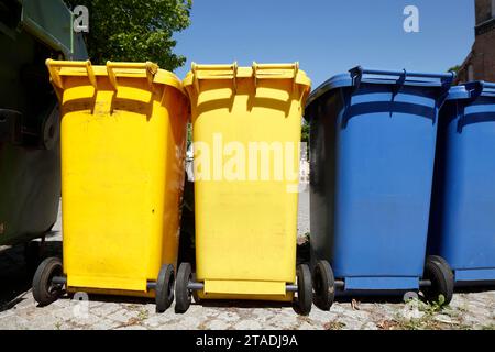 Colourful various recycling bins and waste bins, standing on the street ...