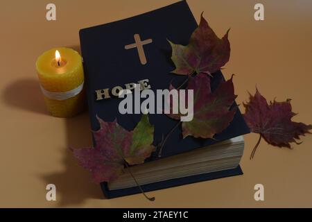 Holy bible, advent candle. Advent concept. Maple leaves Stock Photo - Alamy