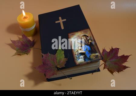 Holy bible, advent candle. Advent concept. Maple leaves Stock Photo - Alamy