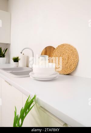 Stack of clean plates near kitchen sink Stock Photo - Alamy