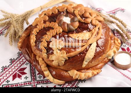 Korovai with wheat spikes on rushnyk, above view. Ukrainian bread and ...