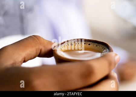 Hot tea with milk in earthen clay pot kulhad chai on white background ...