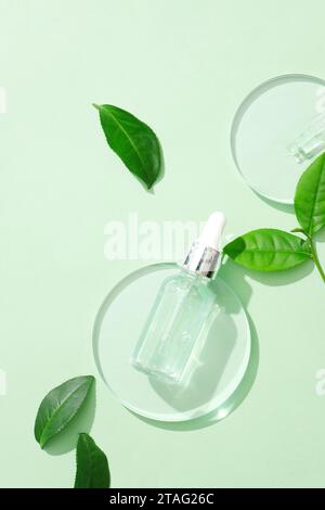 Serum bottle with fresh leaves at pastel background Stock Photo - Alamy