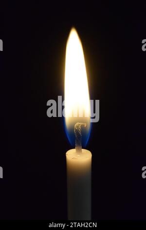 Single small candle burning in the dark Stock Photo - Alamy