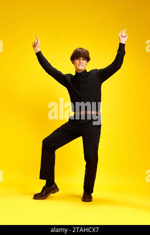 Portrait of positive overjoyed man dressed green hoodie having fun open ...