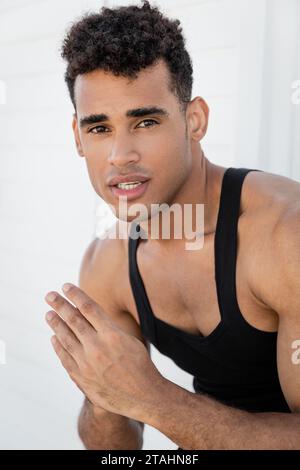 Good looking and muscular young cuban man in black and stylish outfit ...