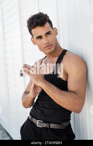 Good looking and muscular young cuban man in black and stylish outfit ...