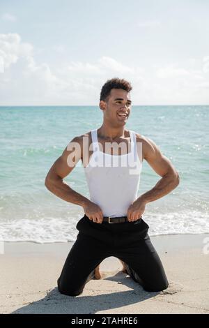 muscular young Cuban man standing in ocean water in Miami South Beach ...