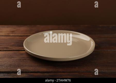 Beautiful beige ceramic plate on gray textured table, top view Stock ...