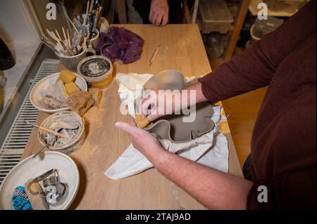 Hands making things with rolled clay in studio Stock Photo - Alamy