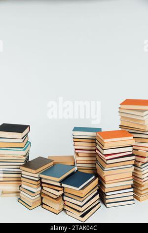 Many Books Piles. Hardback books on wooden table. Back to school. Copy ...