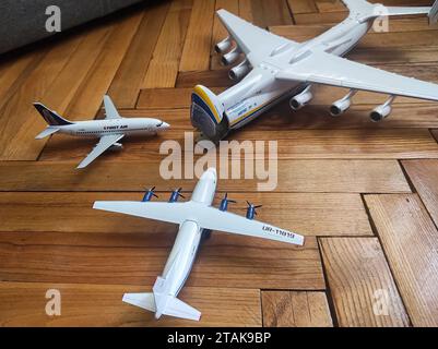 Top view of toy passenger boeing plane with red hearts. Blue wooden ...