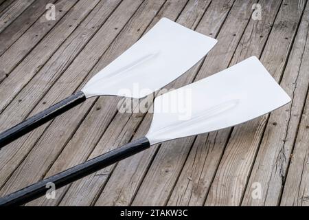 blades of hatchet sculling oars against grunge, rustic wooden deck ...