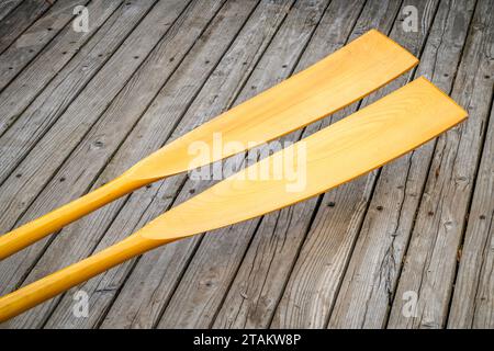 blades of wooden rowing oars against rustic, grunge wood deck Stock ...