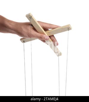 Man holding puppet control bar with strings on white background ...