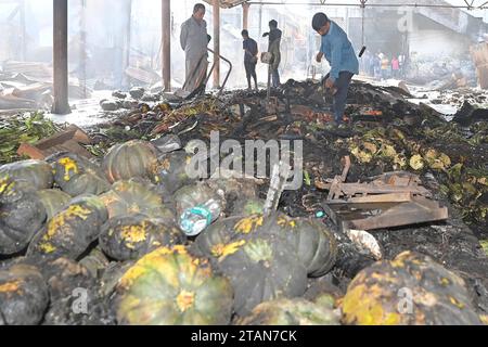 Shop owners and vendors are seen in front of their burnt shops and ...